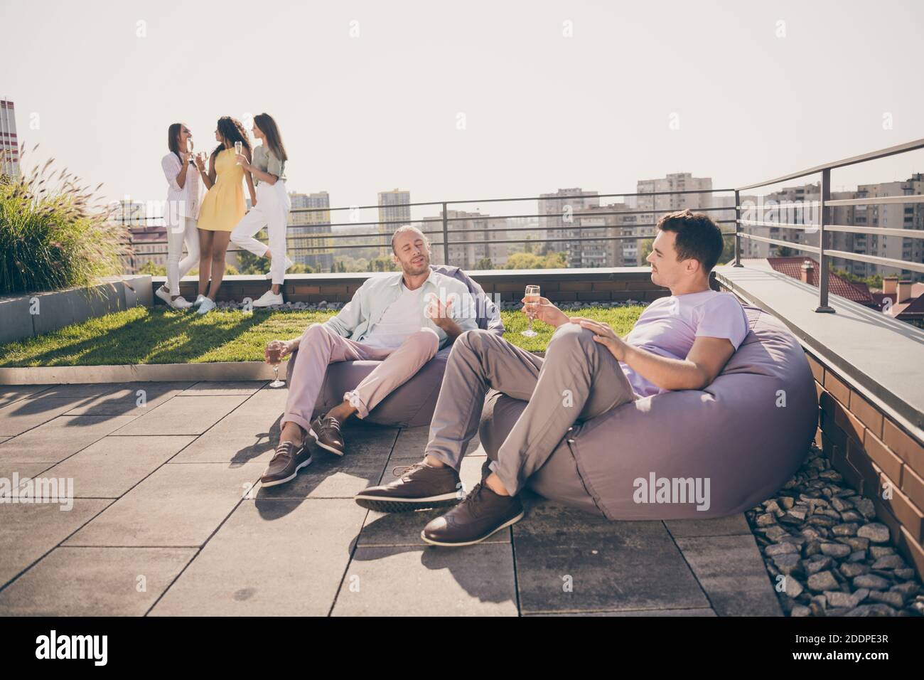 Photo of two young smiling cheerful good mood happy men drink champagne ...