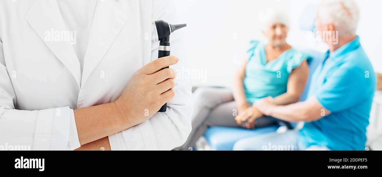 Diagnosis and treatment of hearing. doctor with an otoscope, hearing ...