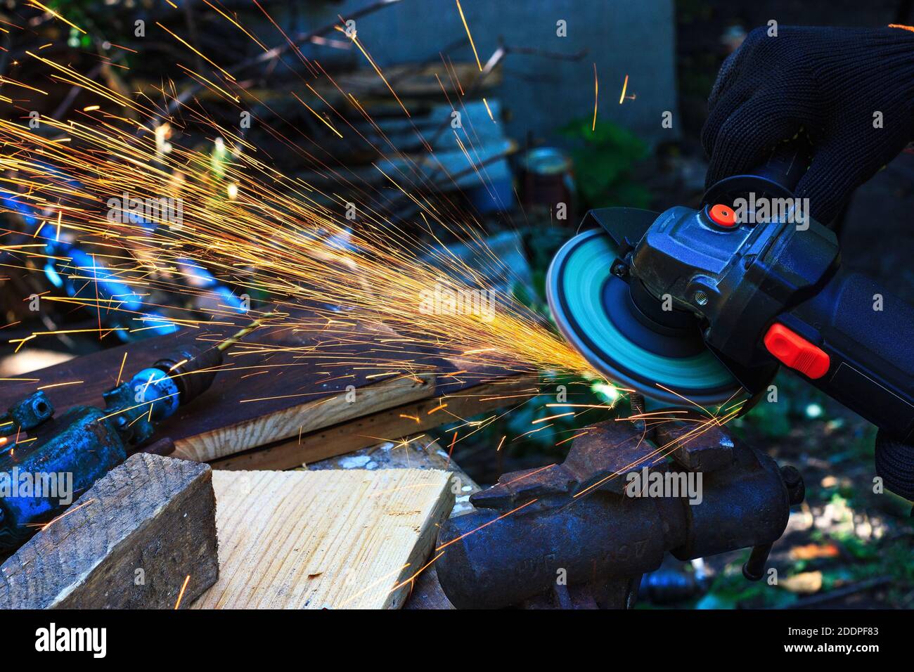 Working with a metal grinder. Locksmith work with sparks Stock Photo ...