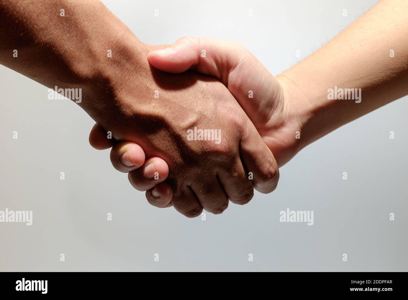 Two men shake hands on white background Stock Photo - Alamy