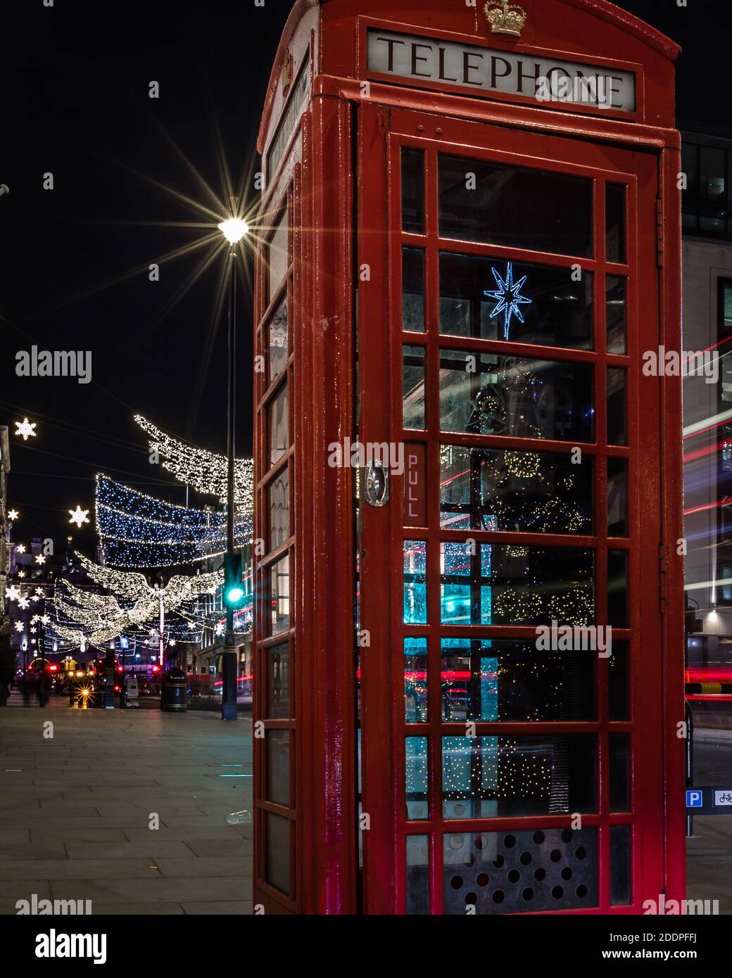 St. James christmas tree reflects on the red telephone box on lower ...