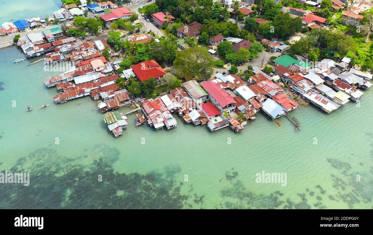 Houses of fishermen in the water in Tagbilaran city. Bohol, Philippines ...
