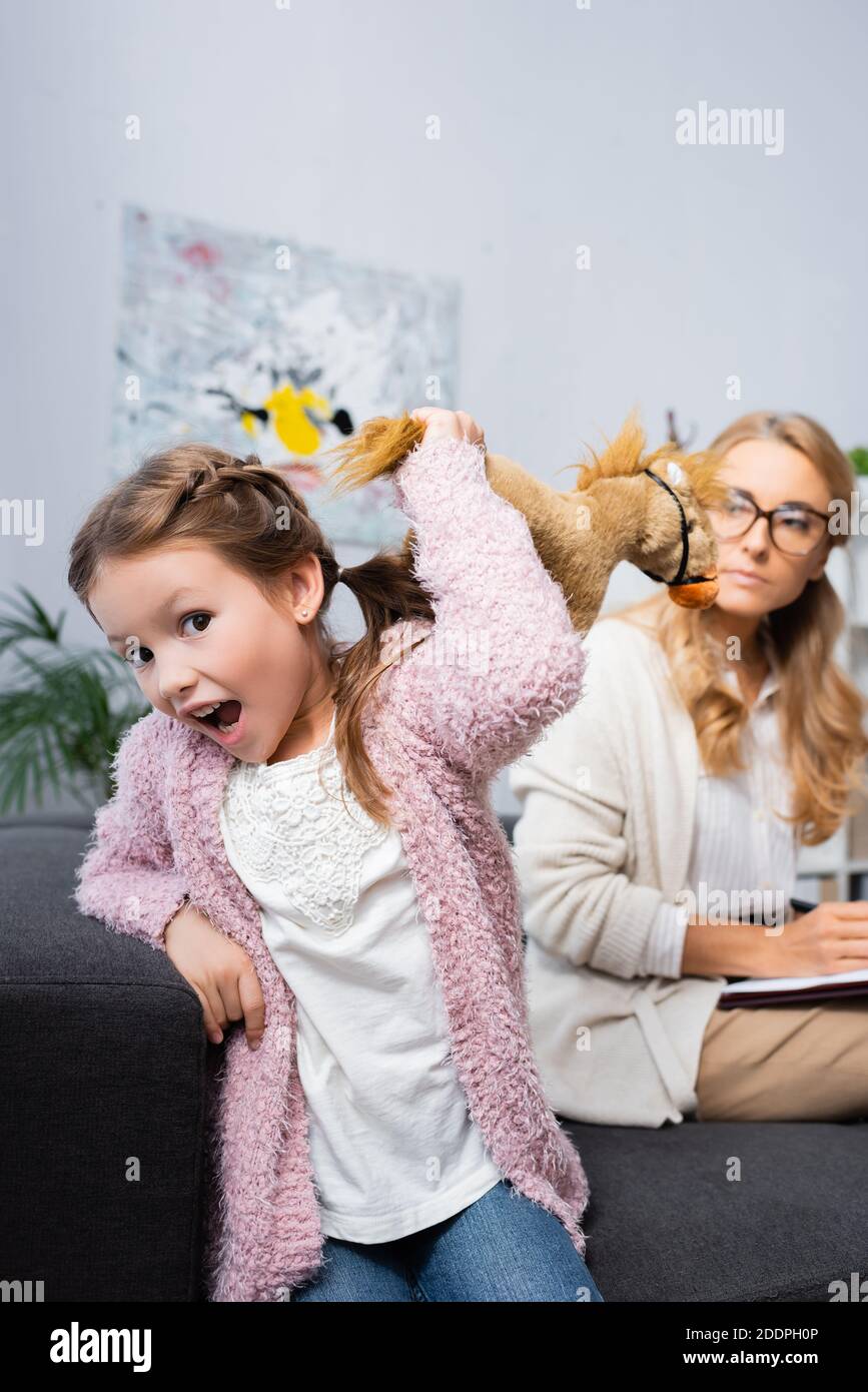 angry little girl throwing toy while visiting psychologist Stock Photo ...