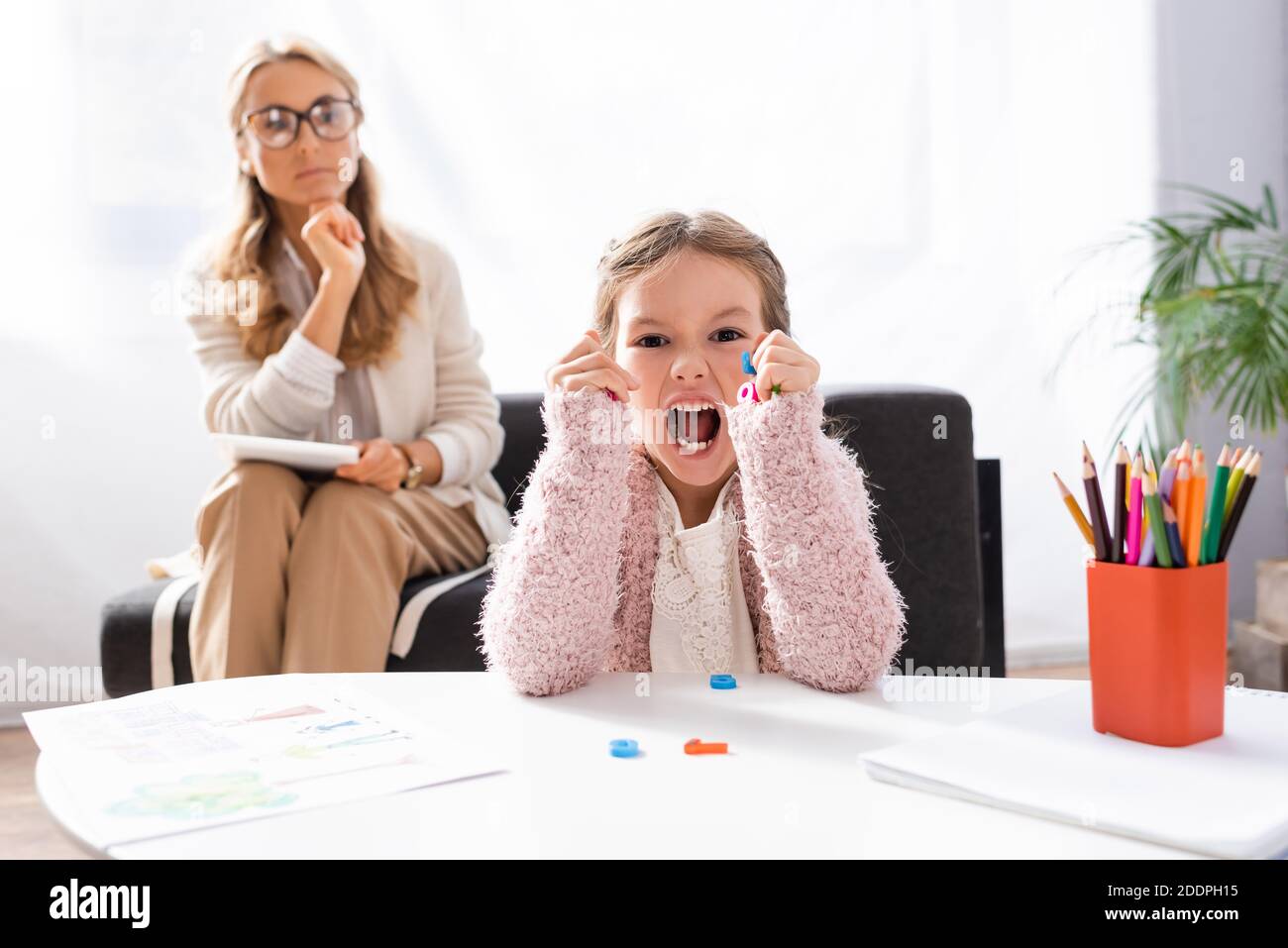 little girl patient screaming and clenching figures while visiting ...