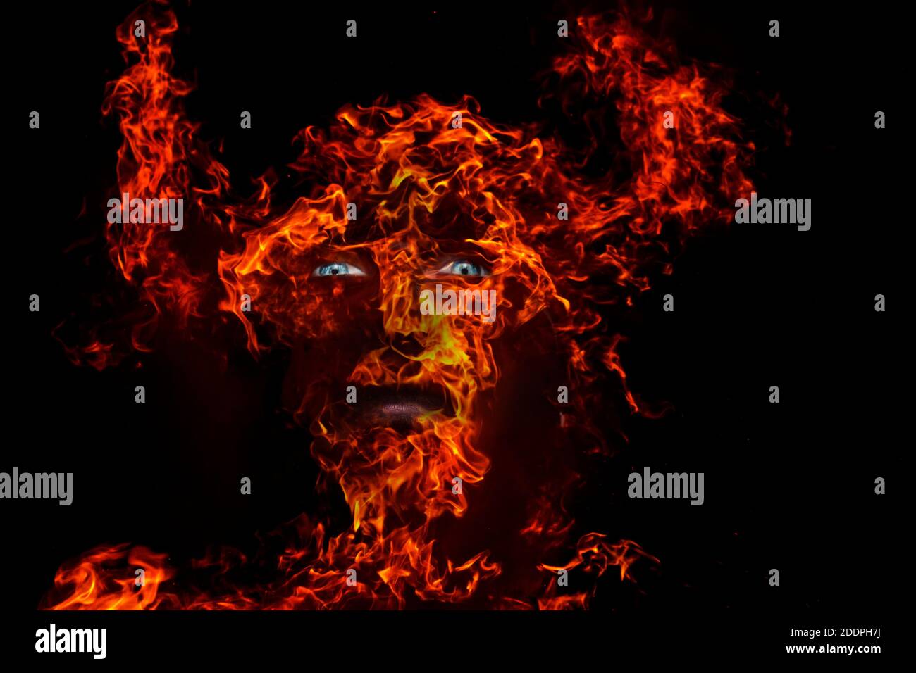 fiery man in a horned helmet and blue eyes Stock Photo - Alamy