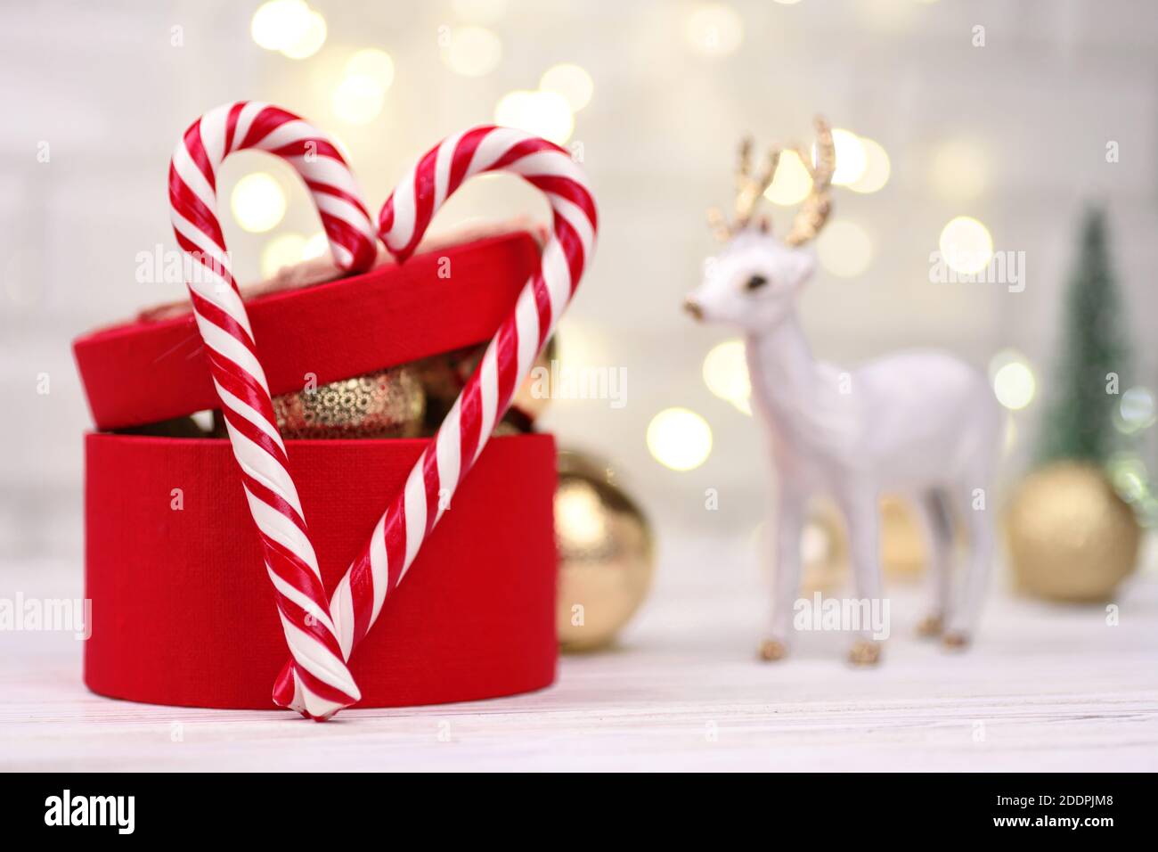 Christmas red gift box Decoration with Candy Canes hearts on gold bokeh ...