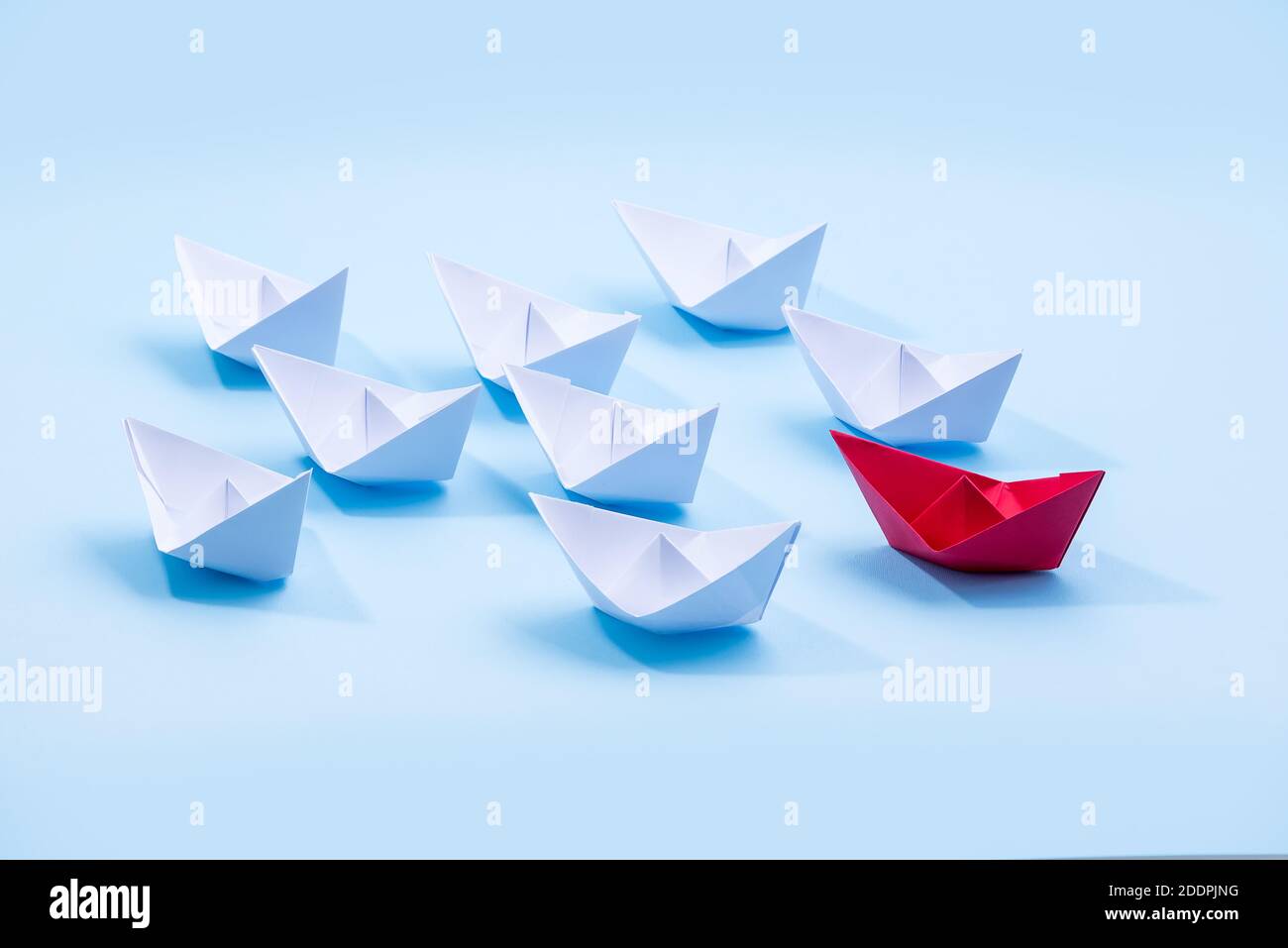 Red and white paper boats. Concept of leadership boats for teamwork ...