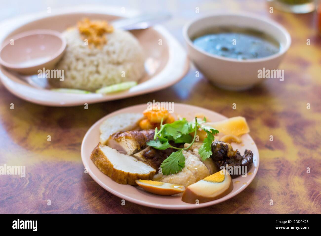 Traditional chicken rice dish, nasi ayam at a local restaurant in Medan ...