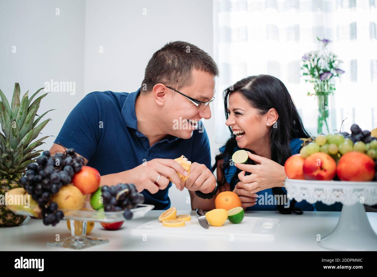 Happy married couple eating fruits. Healthy activity, indoors, cold ...