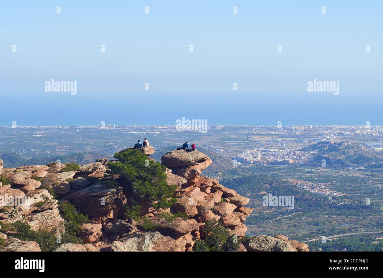 A beautiful view of people sitting on a cliff and enjoying the ...