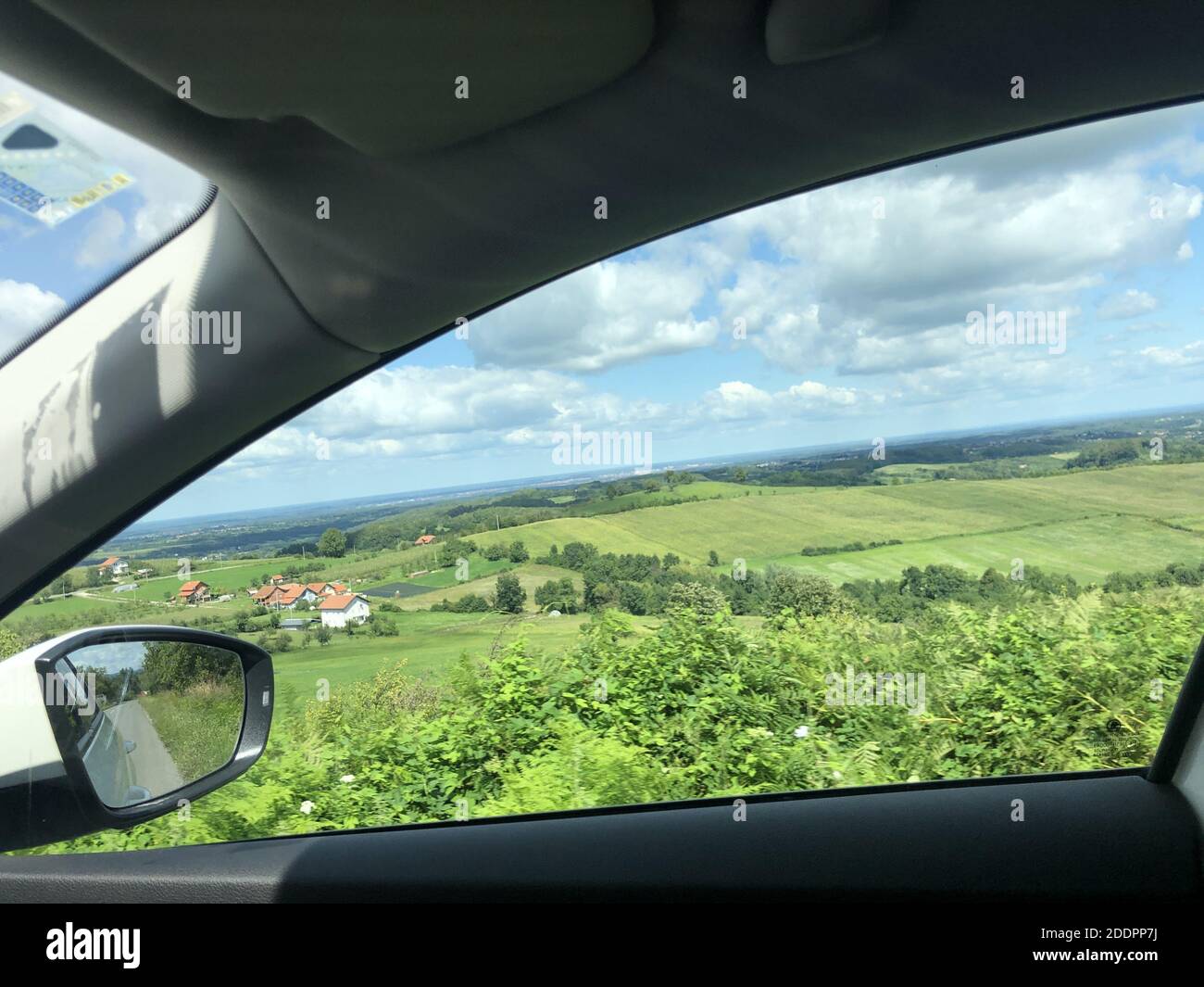a view to the green field under the clouds form the right side rear ...