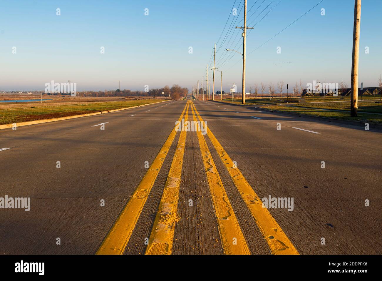 four lane street with crumbling yellow lines on it Stock Photo - Alamy