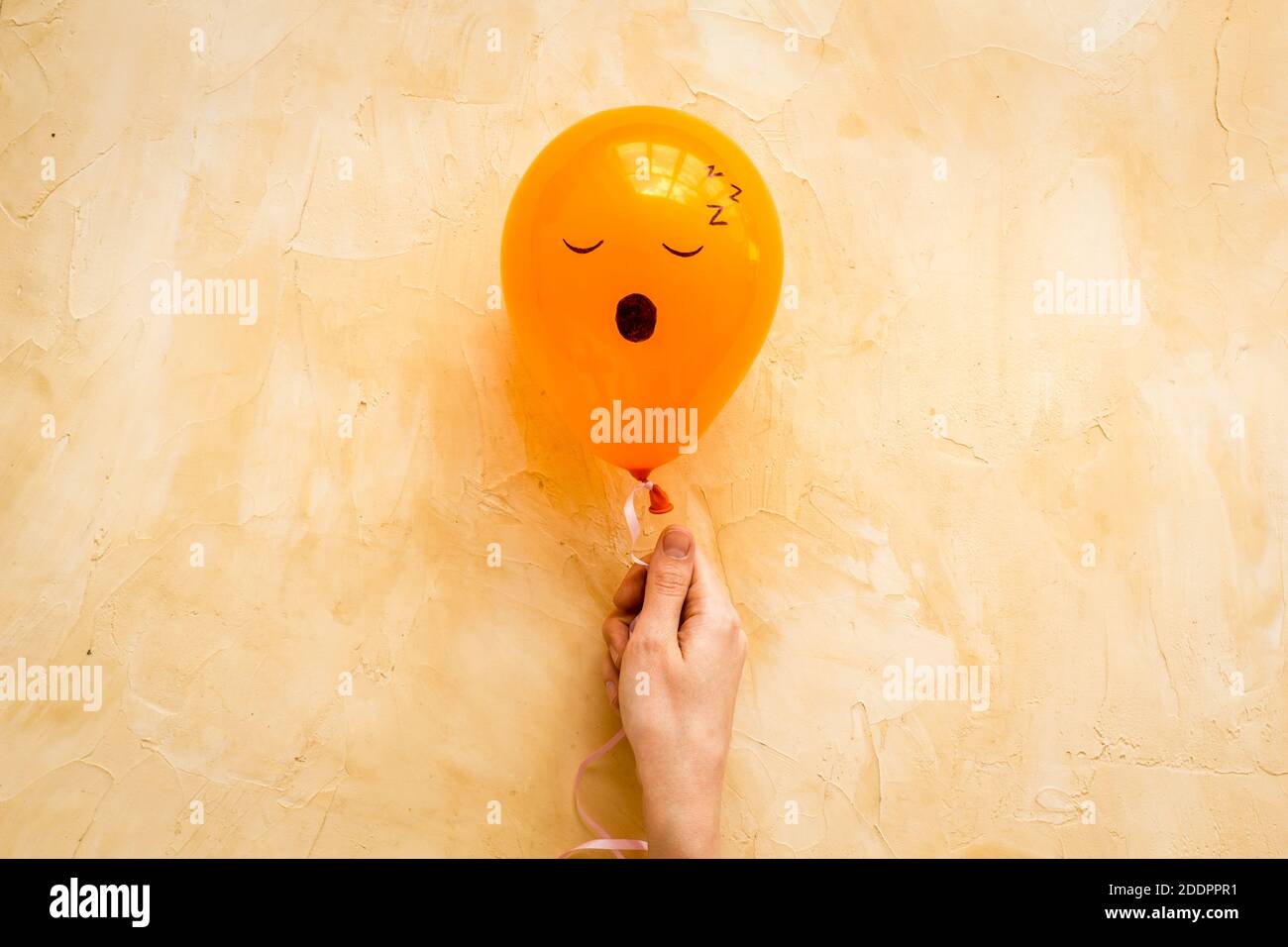 Sleepiness face on balloon - tiredness mood background. Top view, copy ...