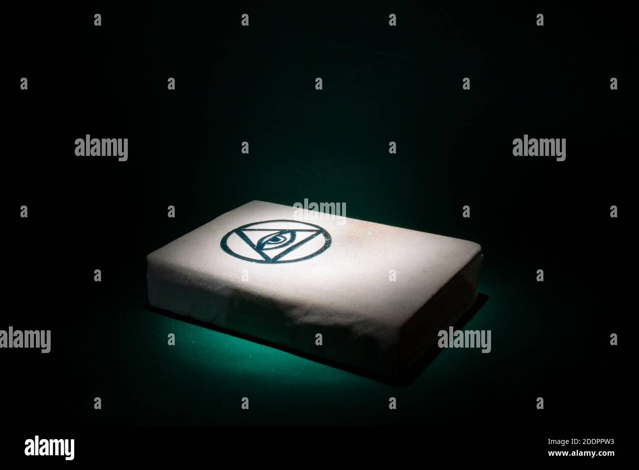 White magic book on green background Stock Photo - Alamy