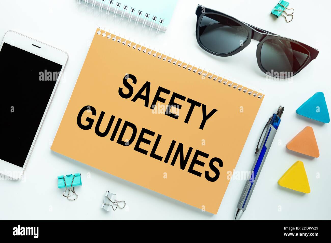 Safety Guidelines is written on a notepad on an office desk with office ...