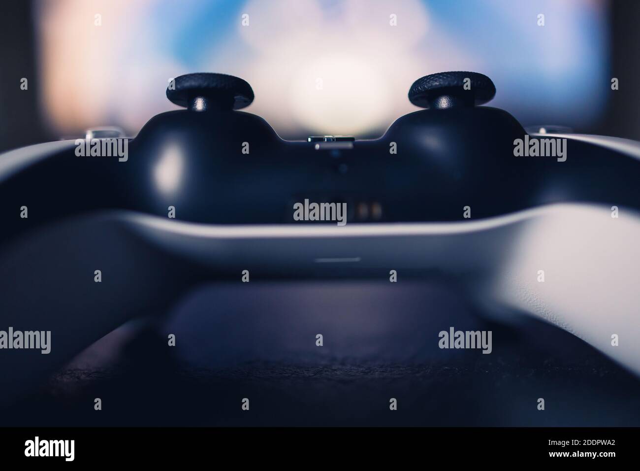 Video games white gaming controller at night with television TV lights ...