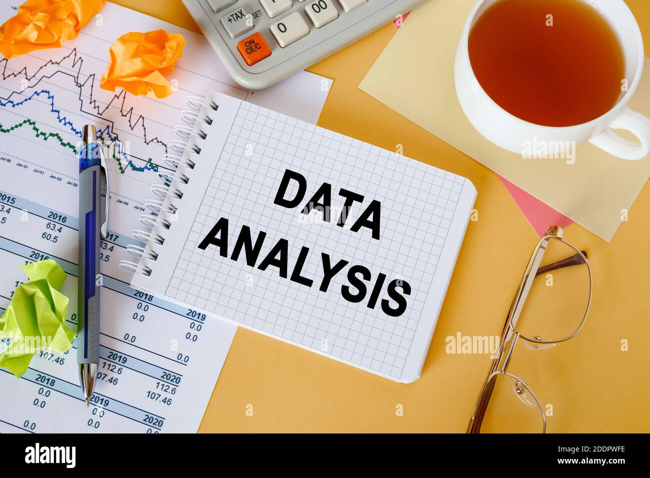 DATA ANALYSIS is written on a notepad on an office desk with office ...