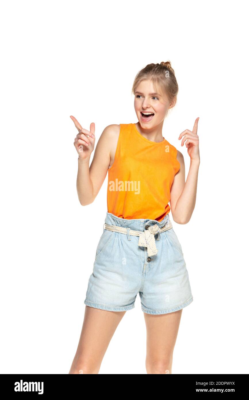 Cheerful female model in casual bright wear isolated on white ...