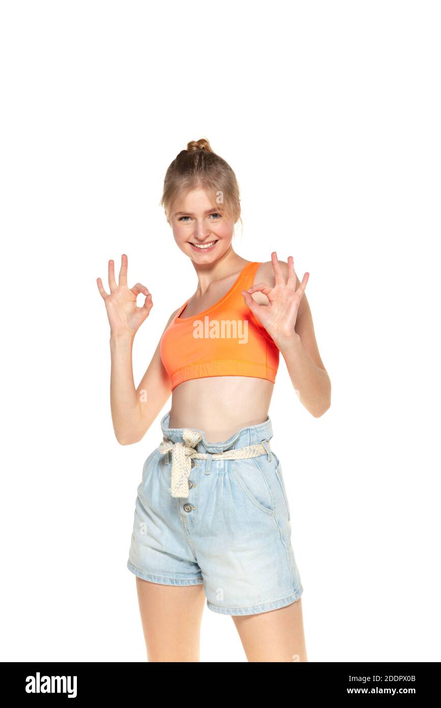 Beautiful and happy model in casual bright wear isolated on white ...