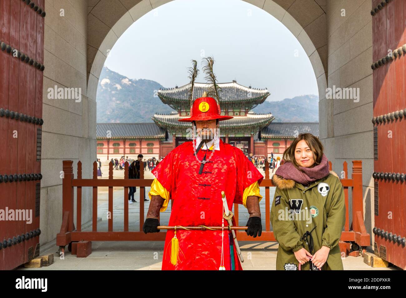A Korean woman taking photos with warriors of the Royal guard in ...