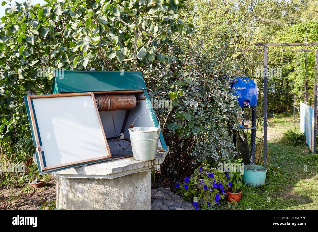Old draw-well in European village. Retro stone water well in rural area ...