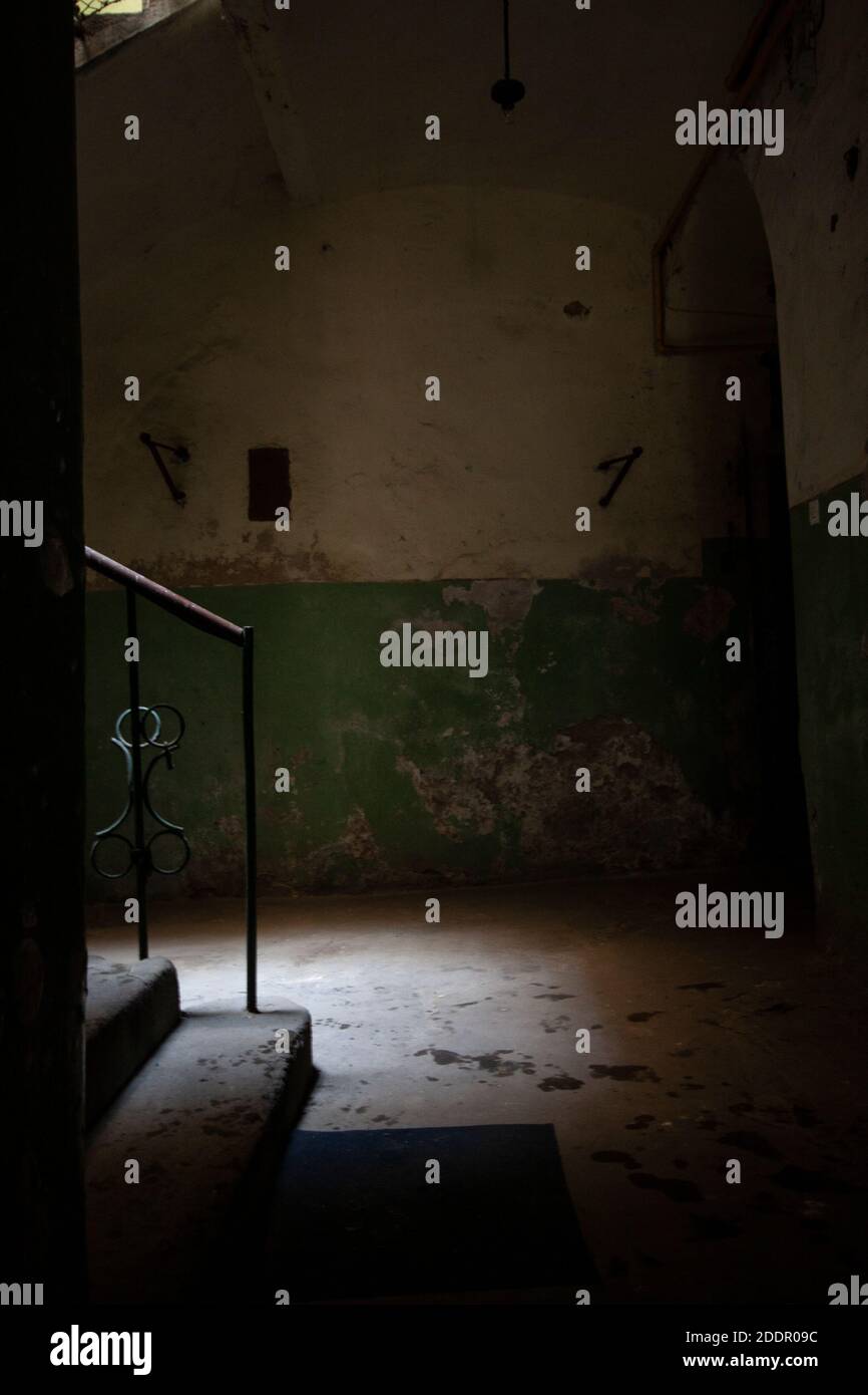 Destroyed staircase with a metal railing nostalgically illuminated by ...
