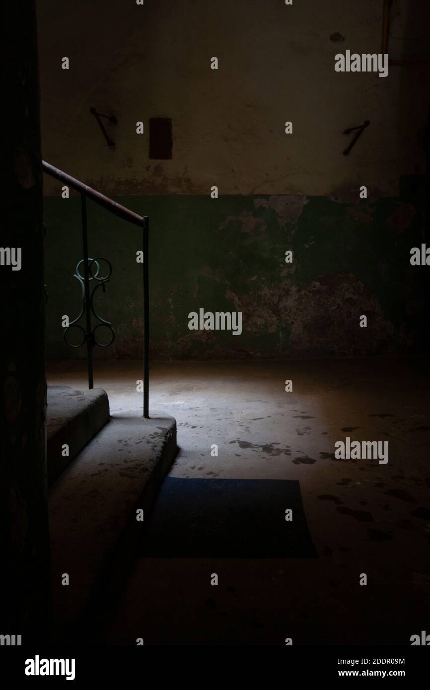 Destroyed staircase with a metal railing nostalgically illuminated by ...