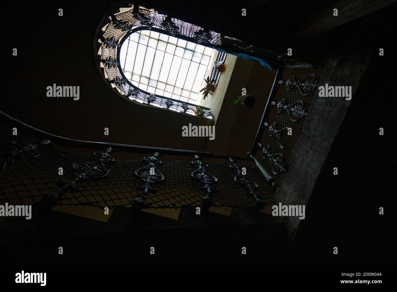 Destroyed staircase with a metal railing nostalgically illuminated by ...