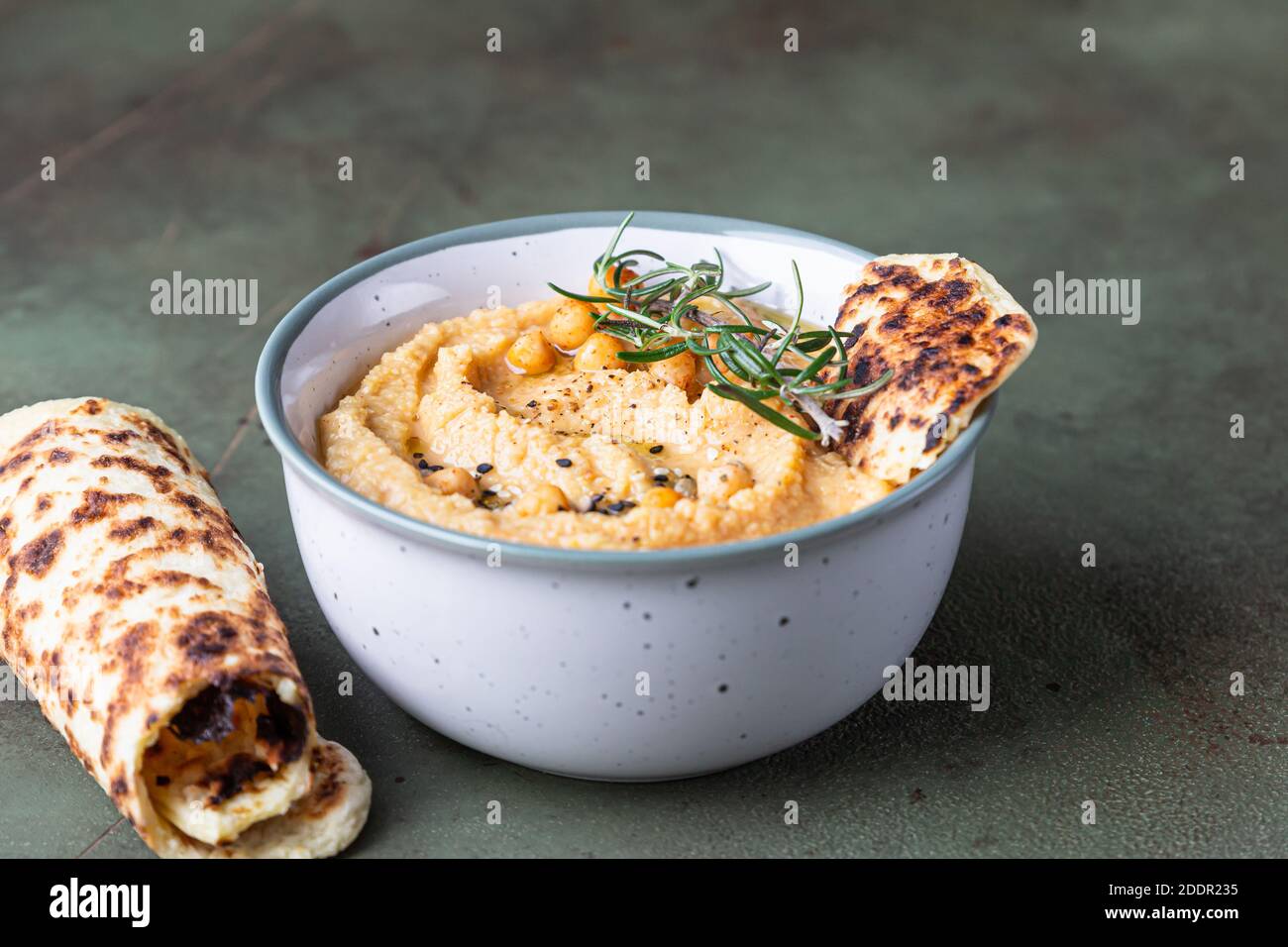 Classic hummus with rosemary, flatbread, boiled chickpea and olive oil ...