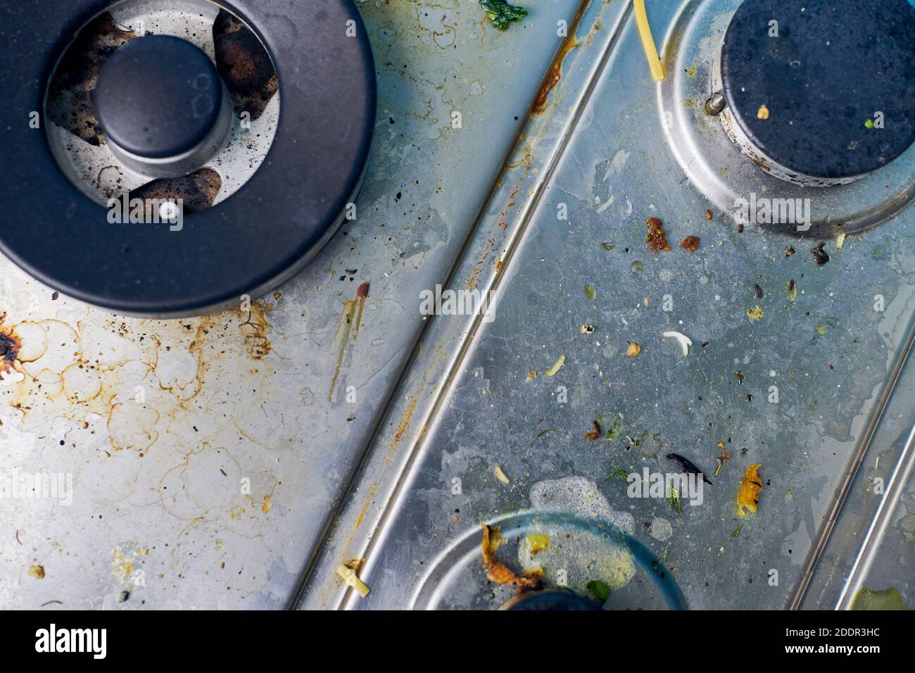 Dirty gas stove top with food leftovers. Unclean steel kitchen cooktop ...