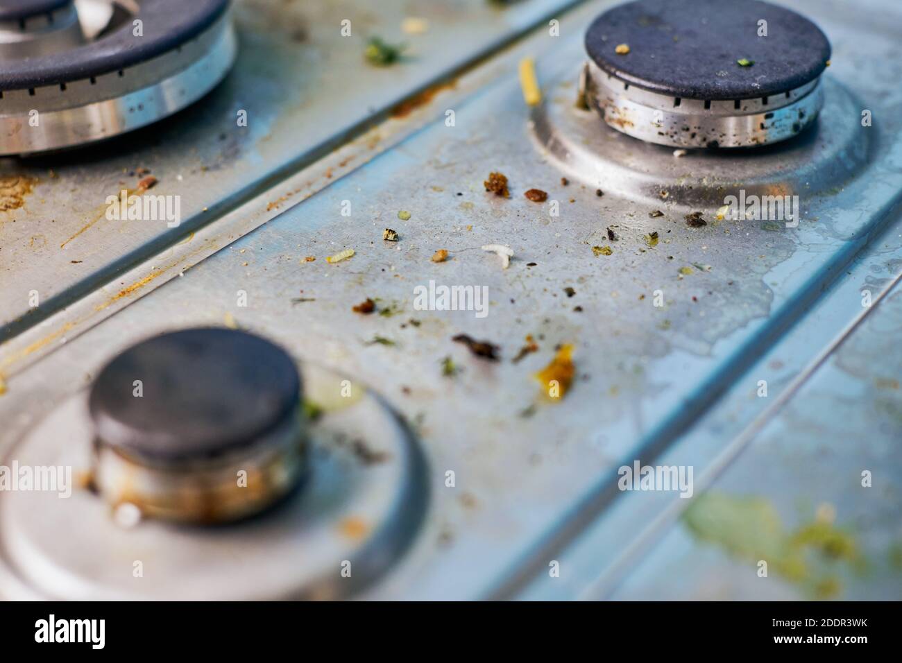 Dirty gas stove top with food leftovers. Unclean steel kitchen cooktop ...