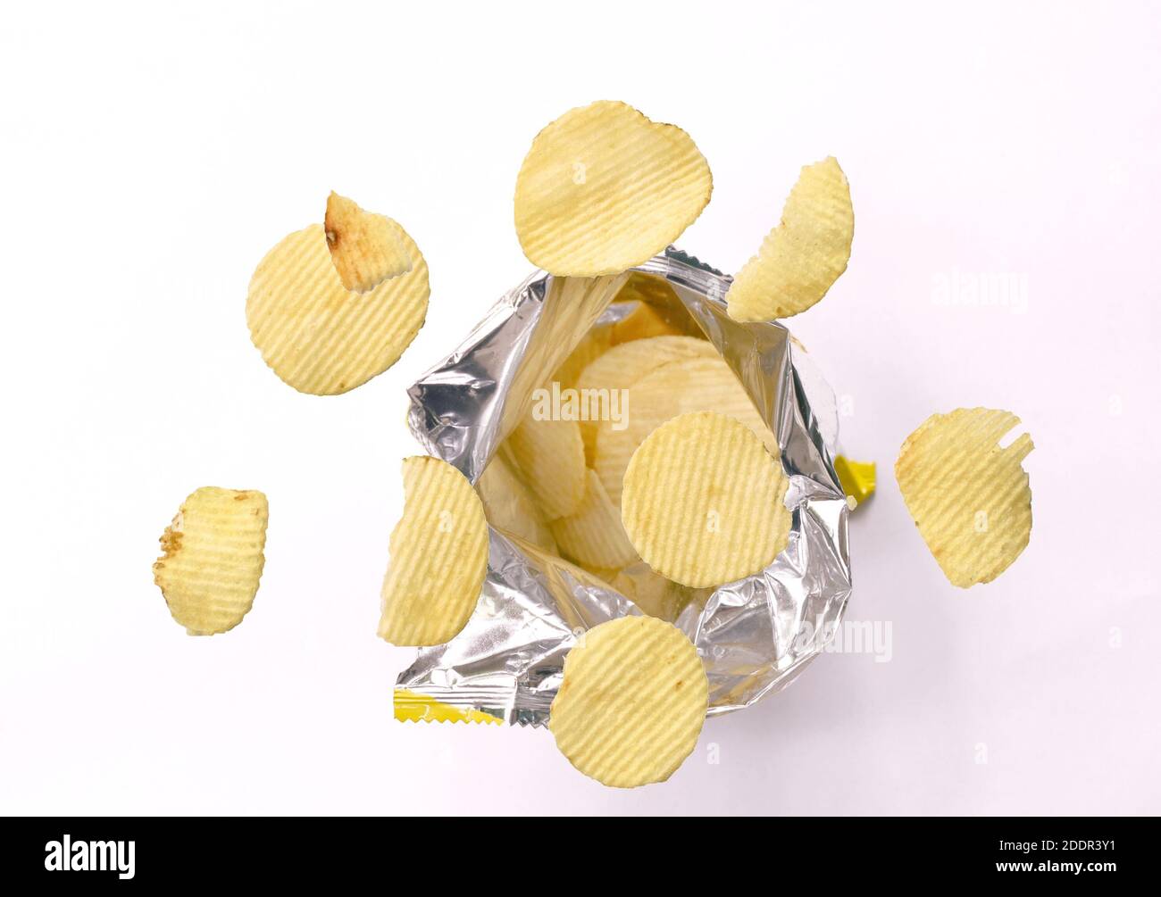 potato chip floating over aluminium foil packaging on white background ...