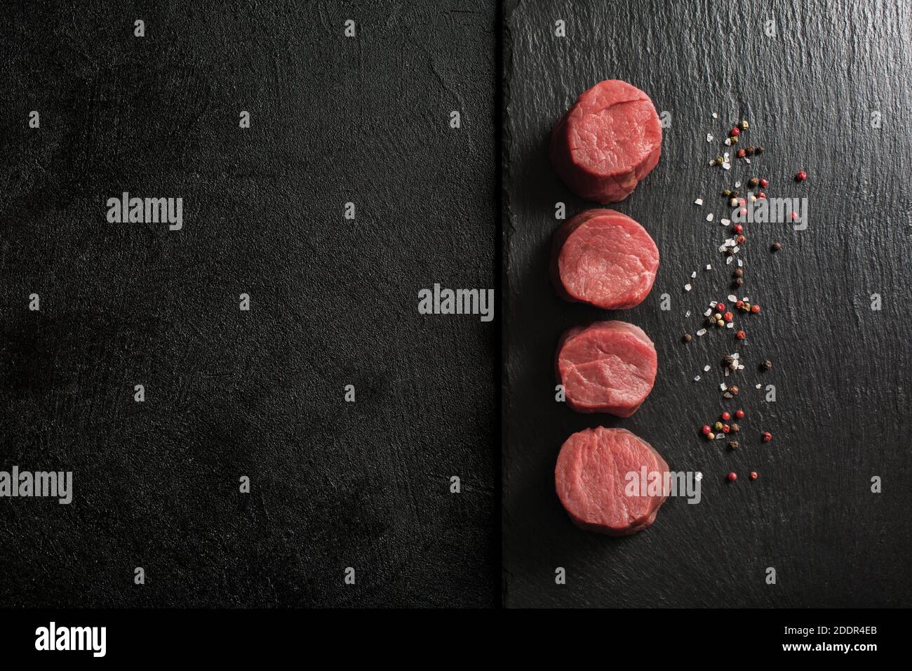 Raw Beef Medallions on a kitchen cutting board Stock Photo - Alamy