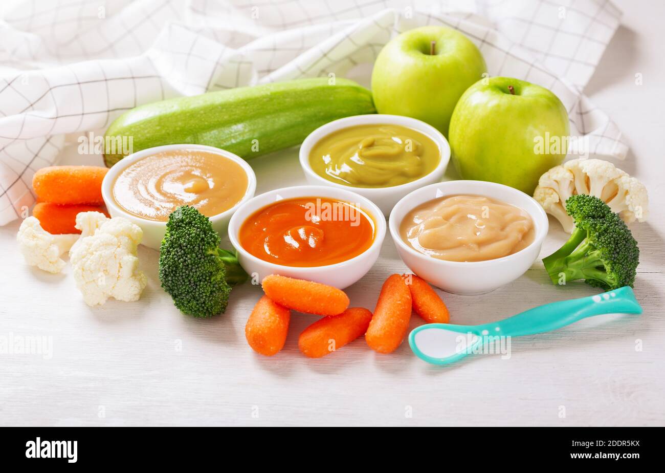 Baby food. Various kinds of bowls of fruit and vegetable puree with ...