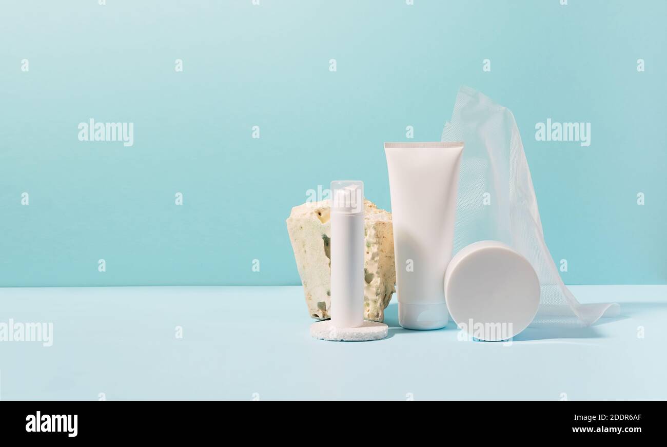 Group of cosmetic tubes of white color bottles on a modern abstract ...