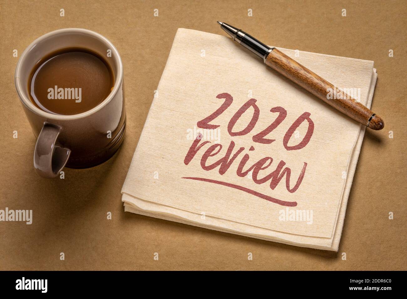 2020 year review - handwriting on a napkin with a cup of coffee, end of ...
