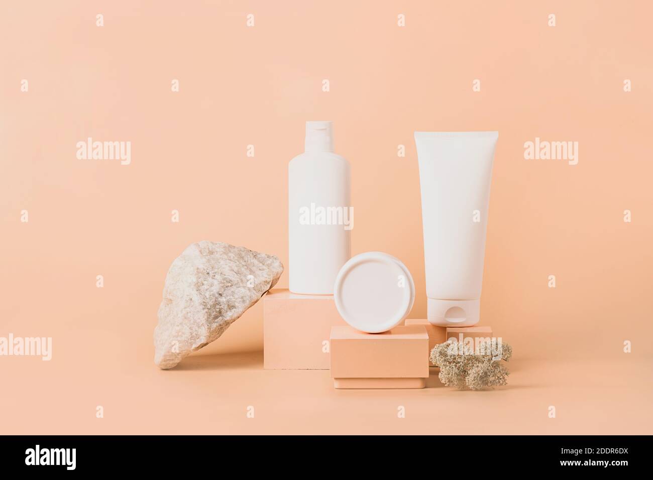 A group of cosmetics in various tubes and bottles on a modern abstract ...