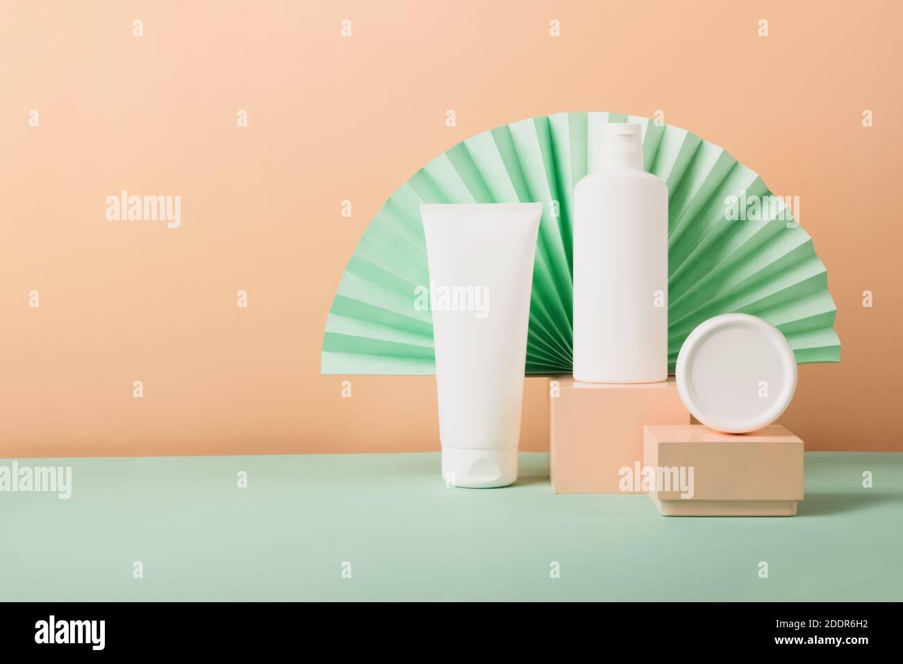 A group of cosmetics in various tubes and bottles on a modern abstract ...