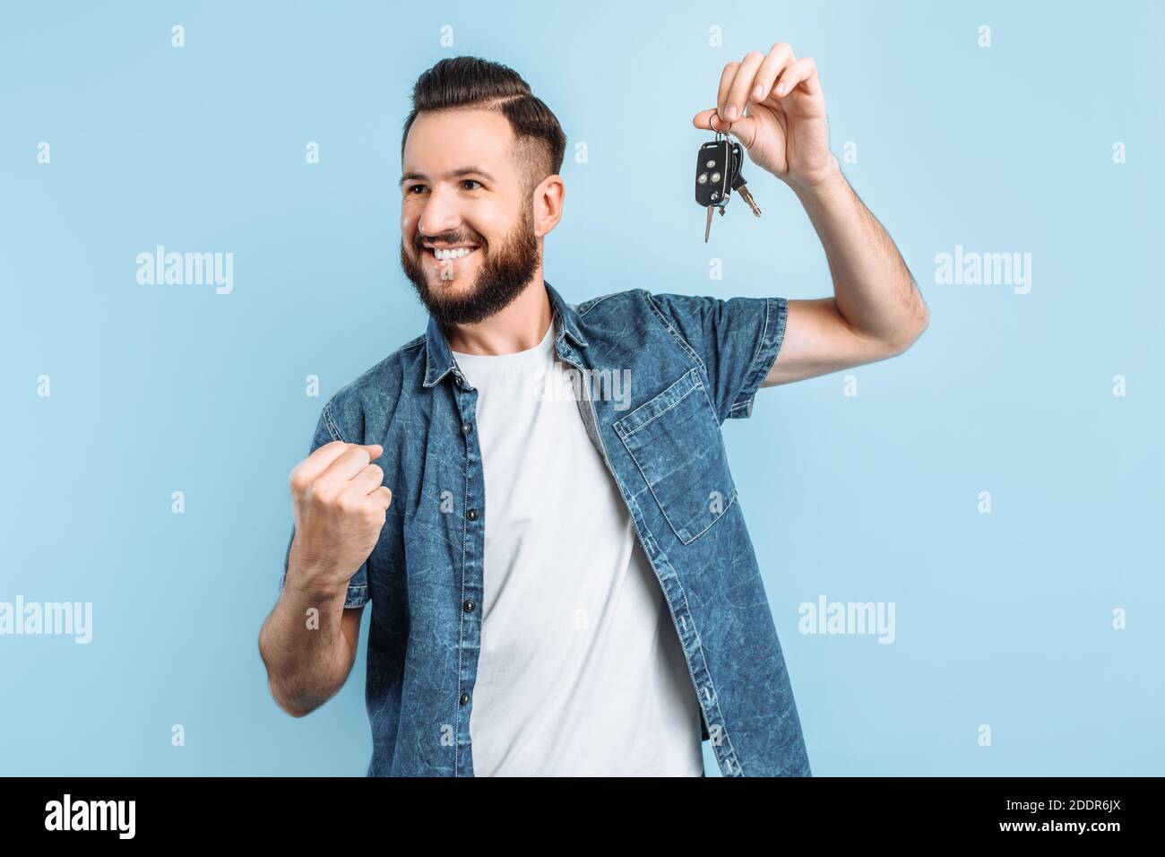 Surprised excited happy man with a beard holding car keys in his hands ...