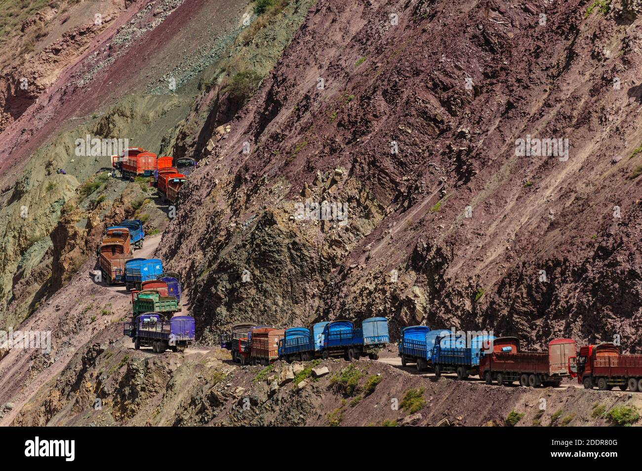 Line of trucks stuck in a traffic jam in an impossibly narrow and ...