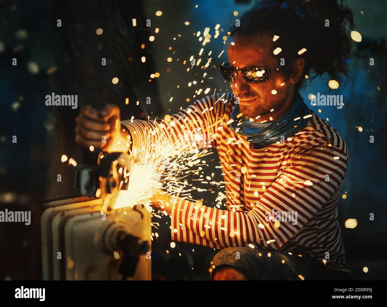 Worker cutting metal with grinder. Sparks while grinding iron Stock ...