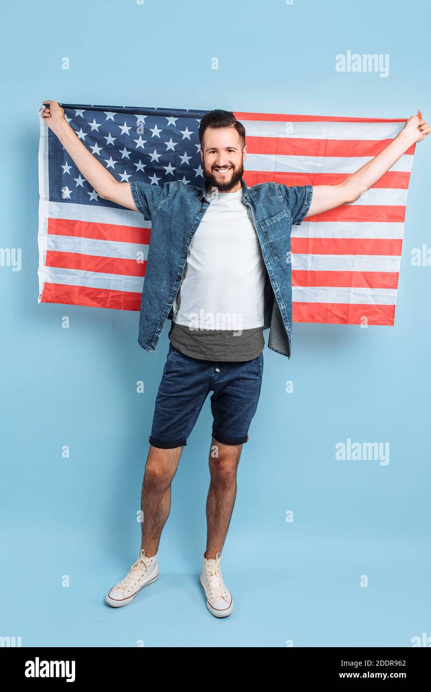 Independence day celebration. The stars and stripes. A young man with ...