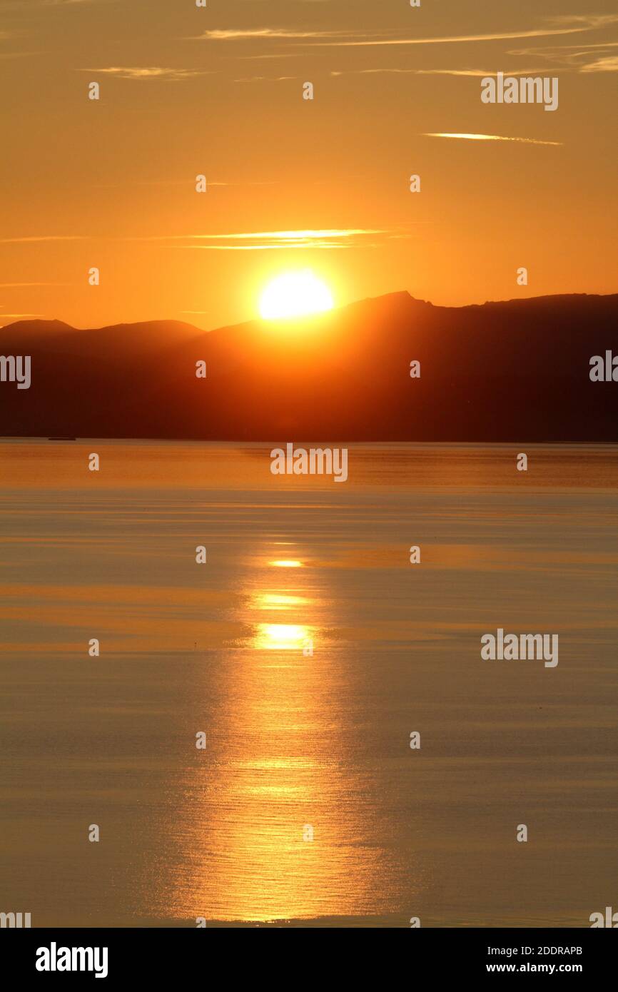 The Isle of Arran, Scotland, UK.Sunset over the island from the beach ...