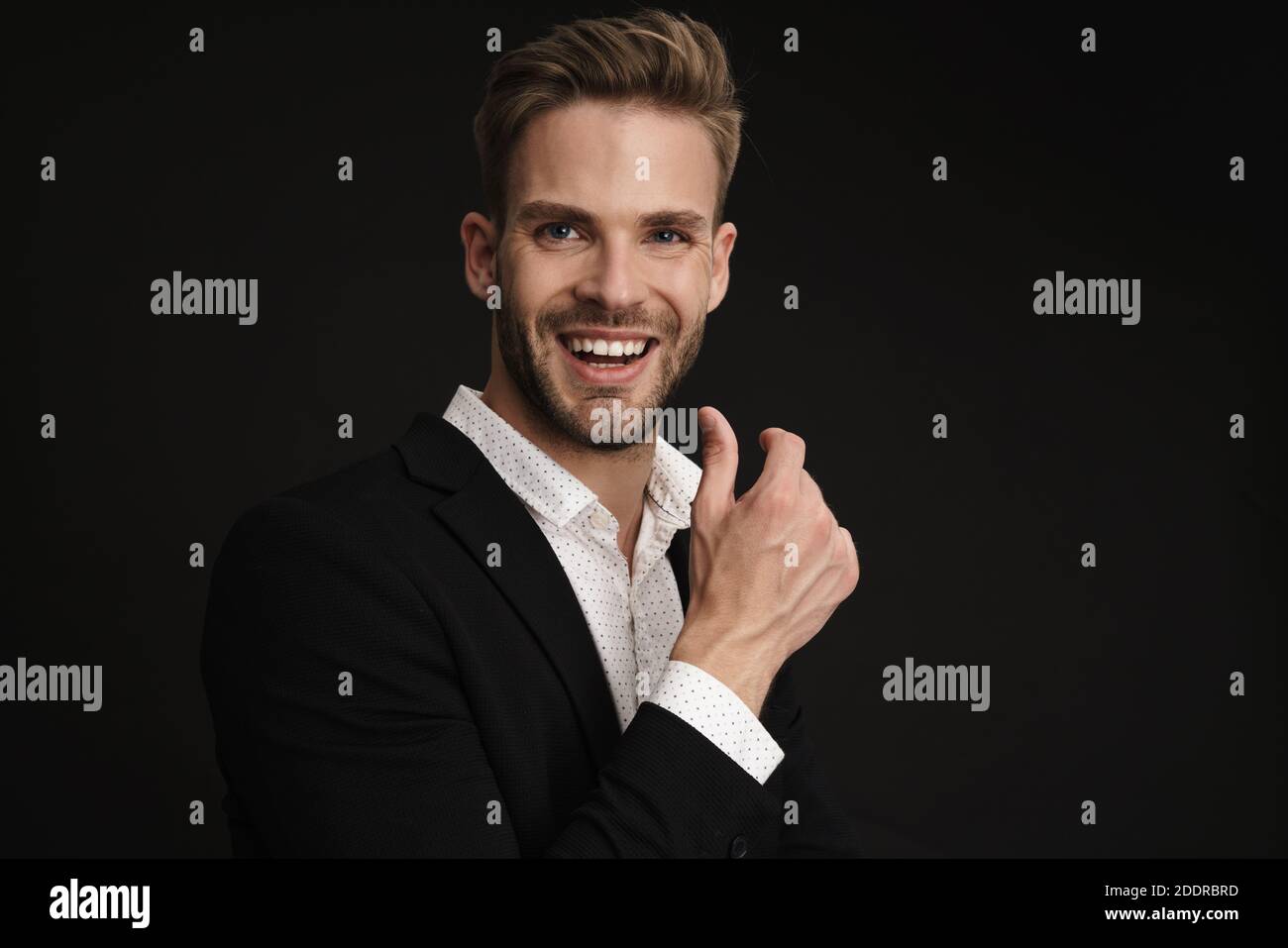 Happy handsome unshaven businessman looking and smiling at camera ...