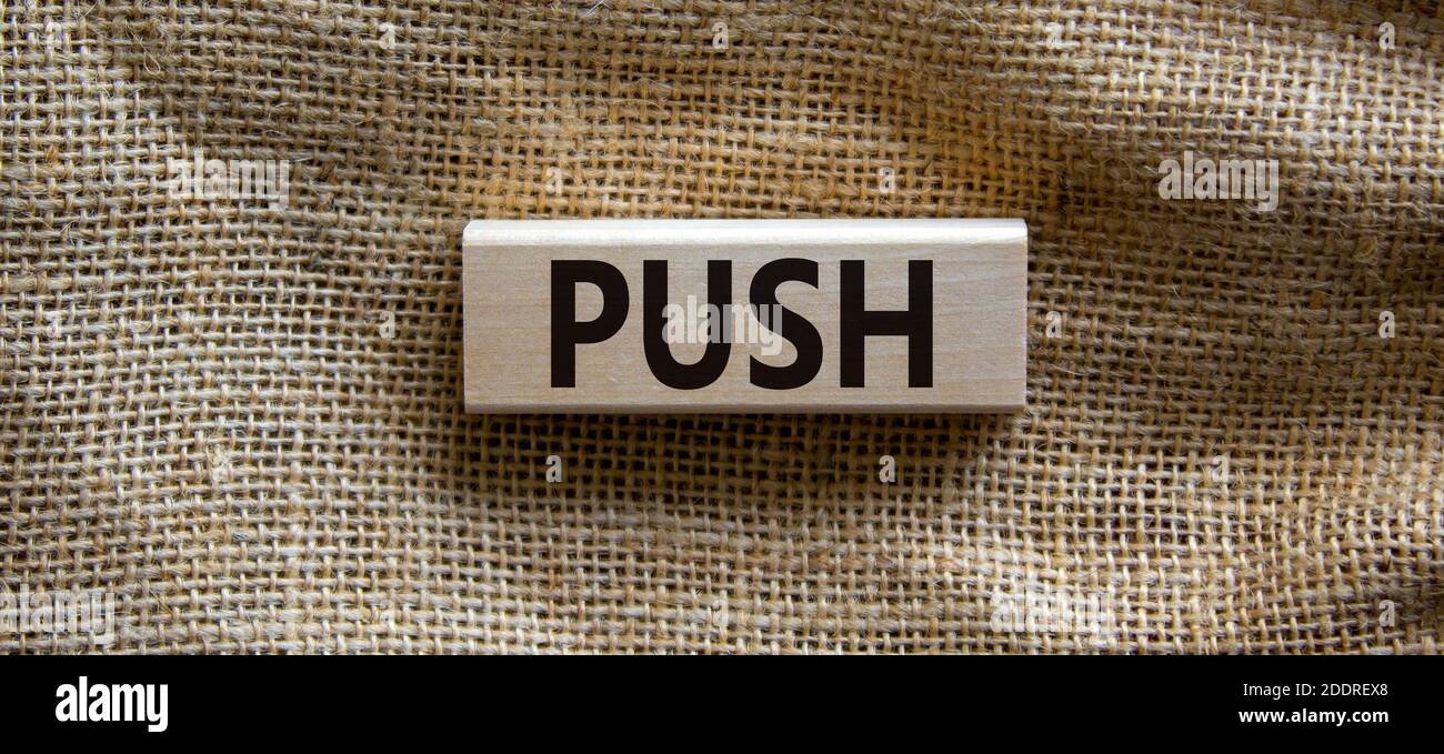 Wooden block form the word 'push' on beautiful canvas background ...