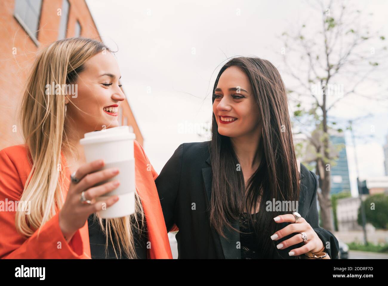Two young friends walking together outdoors Stock Photo - Alamy