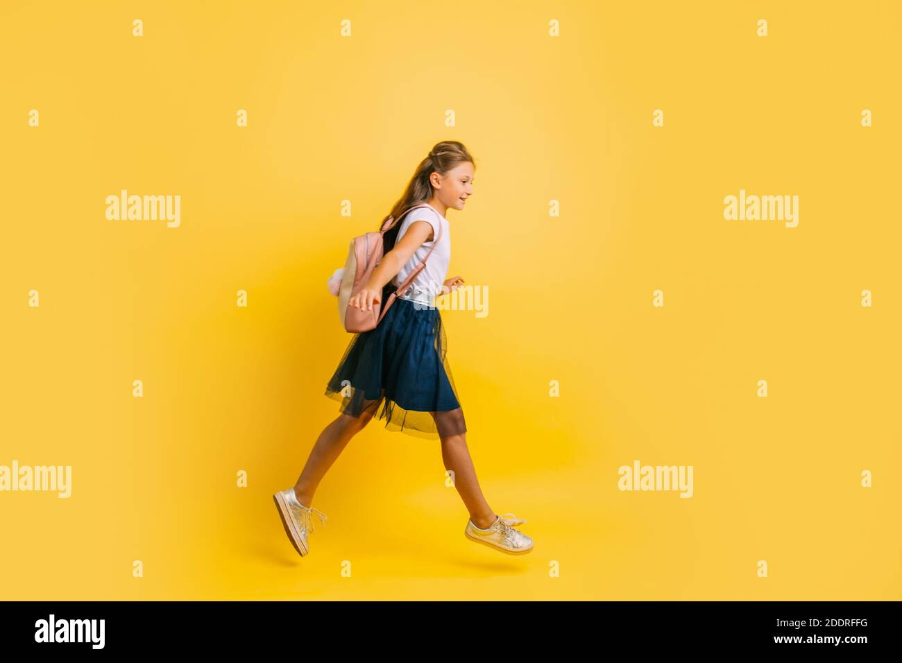 I'm in a hurry. Active little child in school clothes happy stylish ...