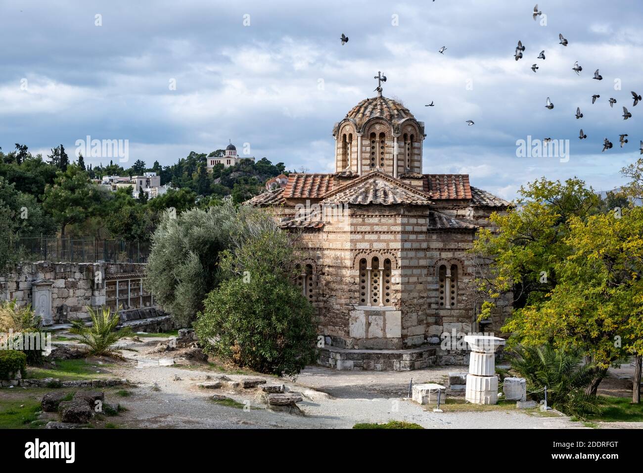 Flock of pigeons flying around the Greek Orthodox church in Thissio ...