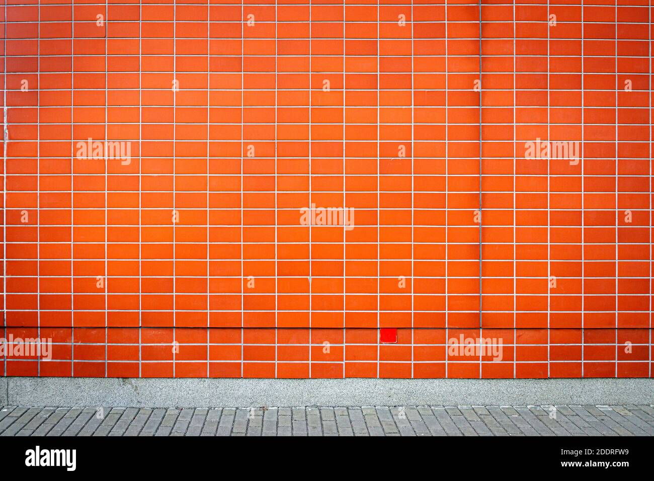 Modern red clay tile wall and a sidewalk Stock Photo - Alamy