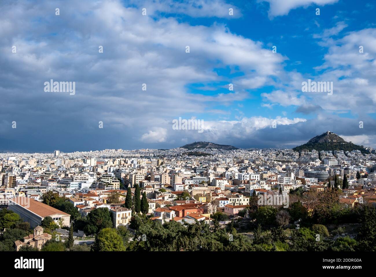 Mount Lycabettus and Athens cityscape view from Acropolis hill in Greece, blue cloudy sky, sunny ...